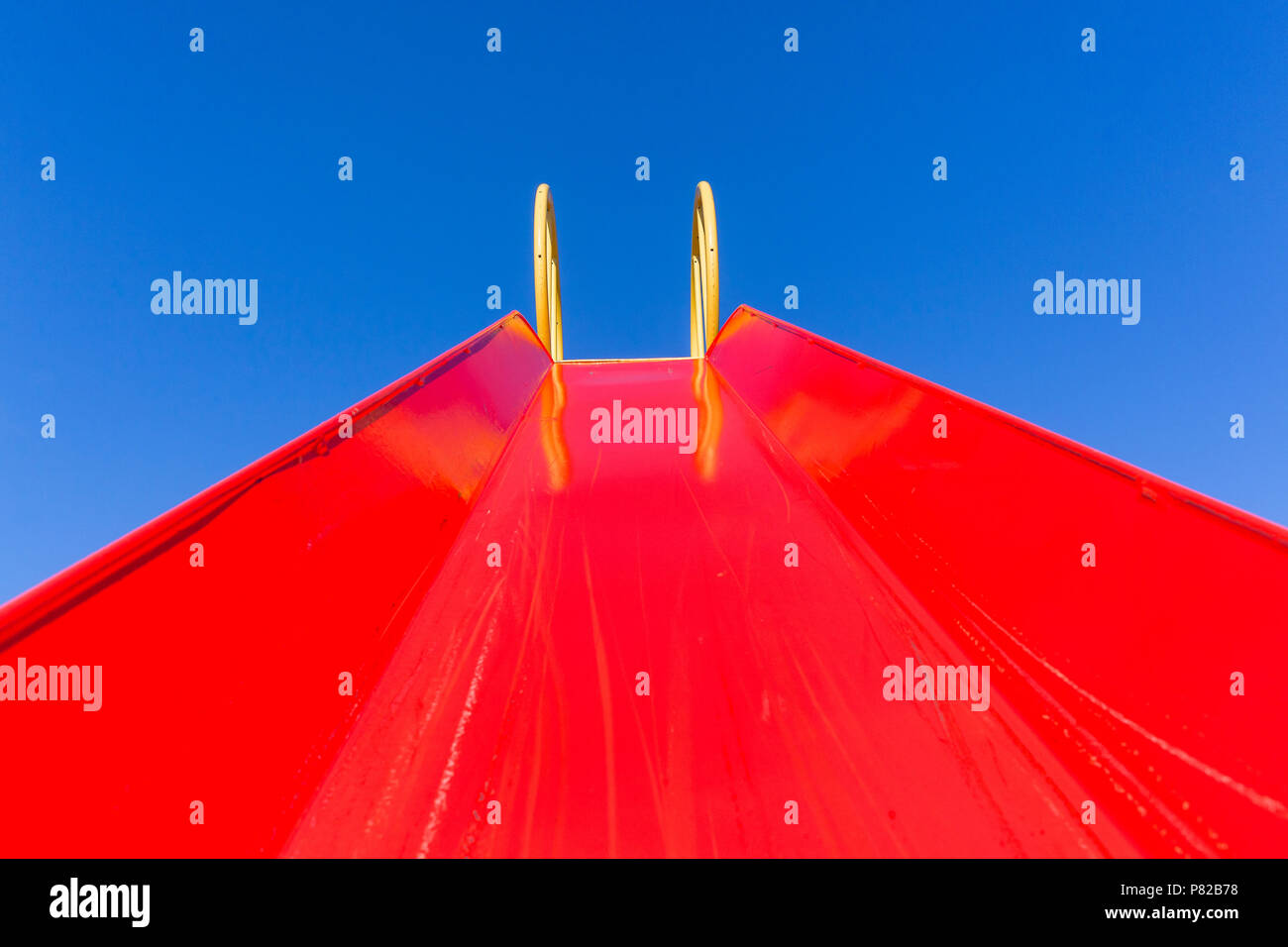 Playground closeup inside children's red painted slide chute looking ...