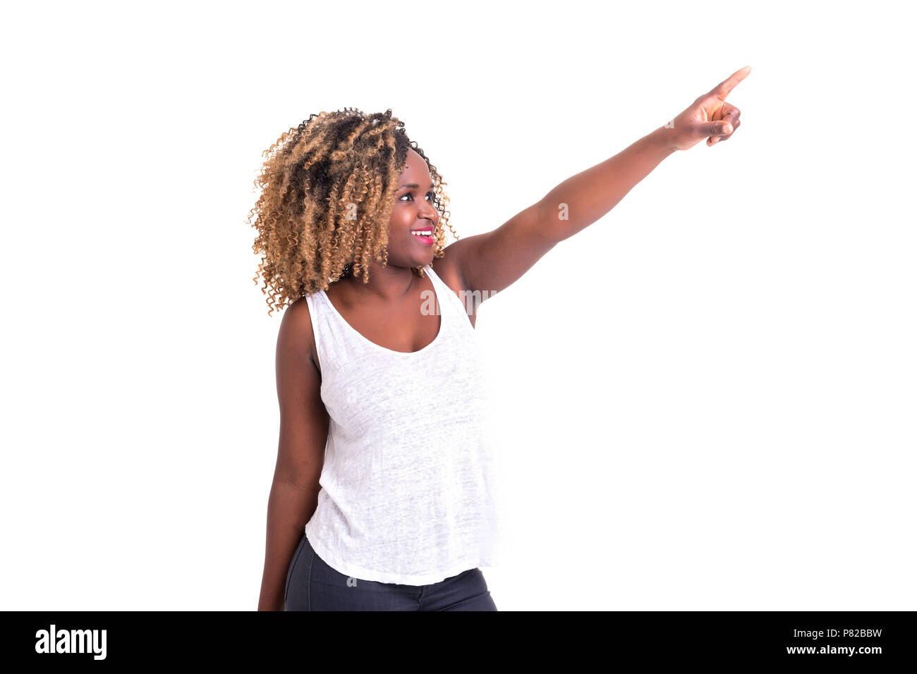 A beautiful woman pointing to something, isolated over a white ...