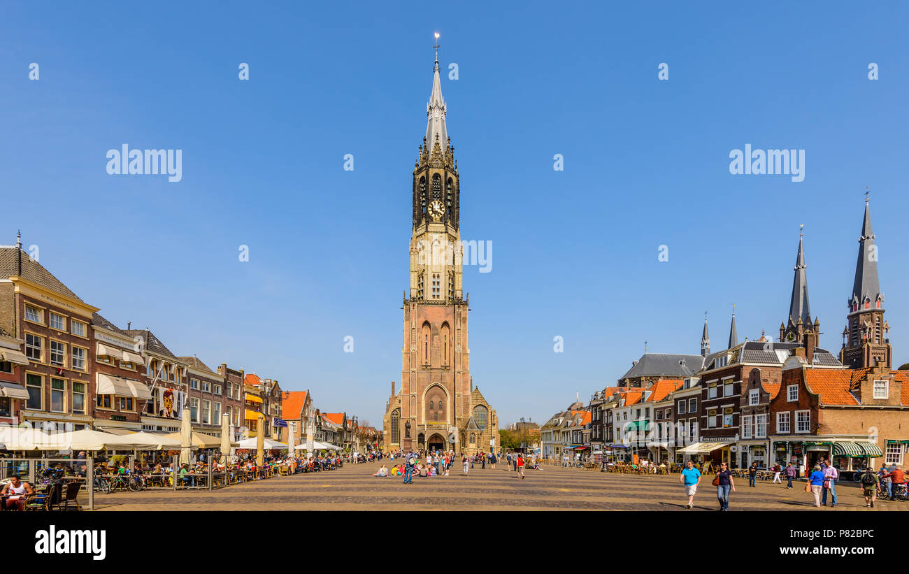 Delft historical center market square with people sitting on terraces ...