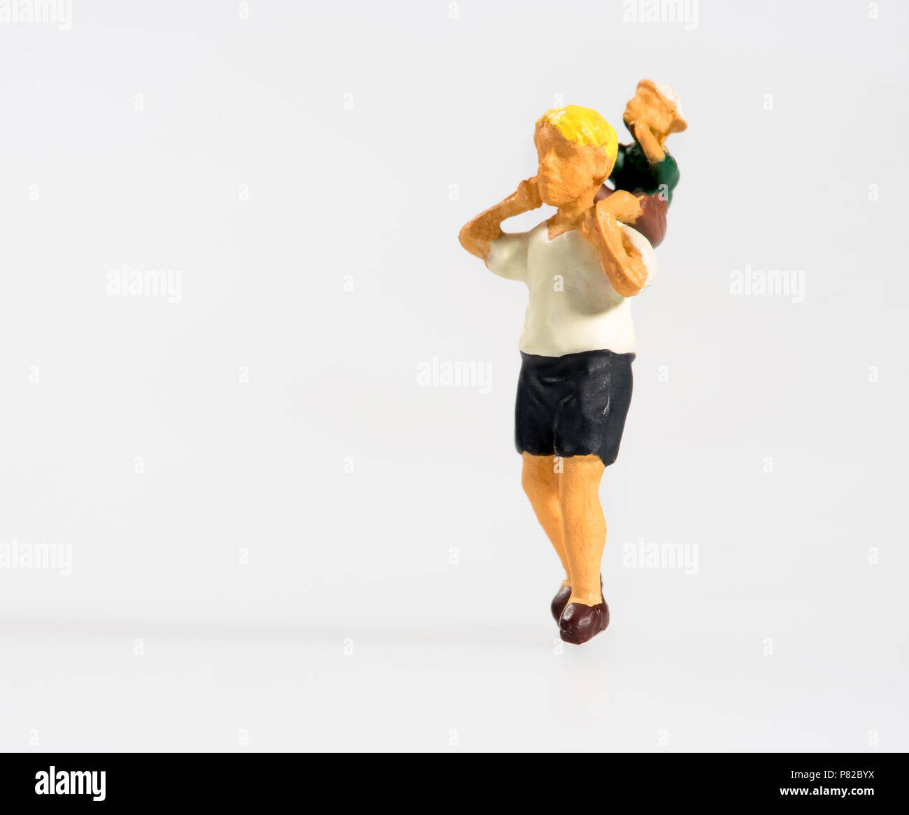 Miniature of father holding his small son on shoulders against white ...