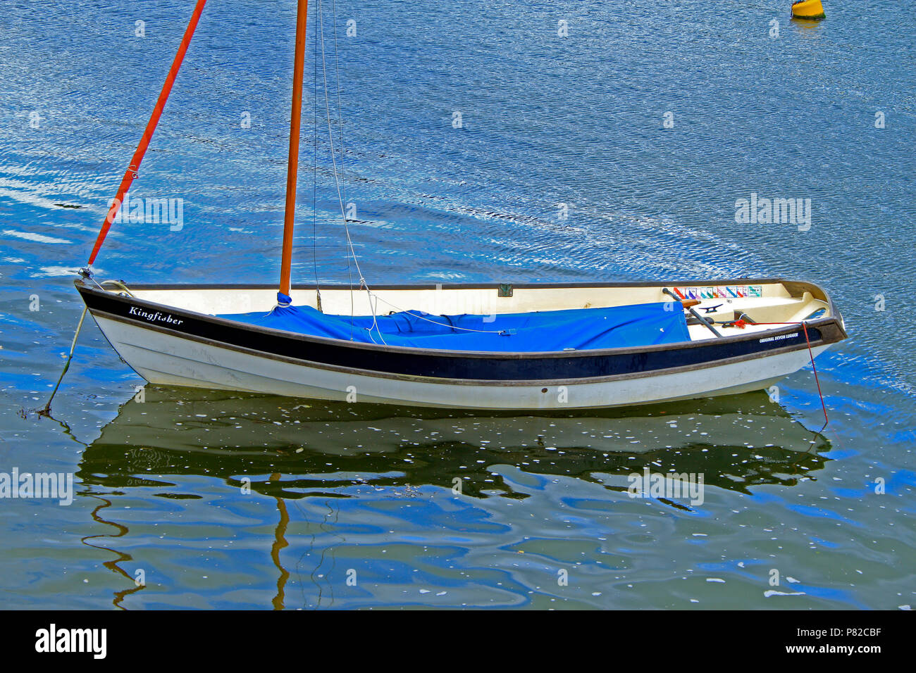 Blue boat bobbing in a blue sea Stock Photo - Alamy