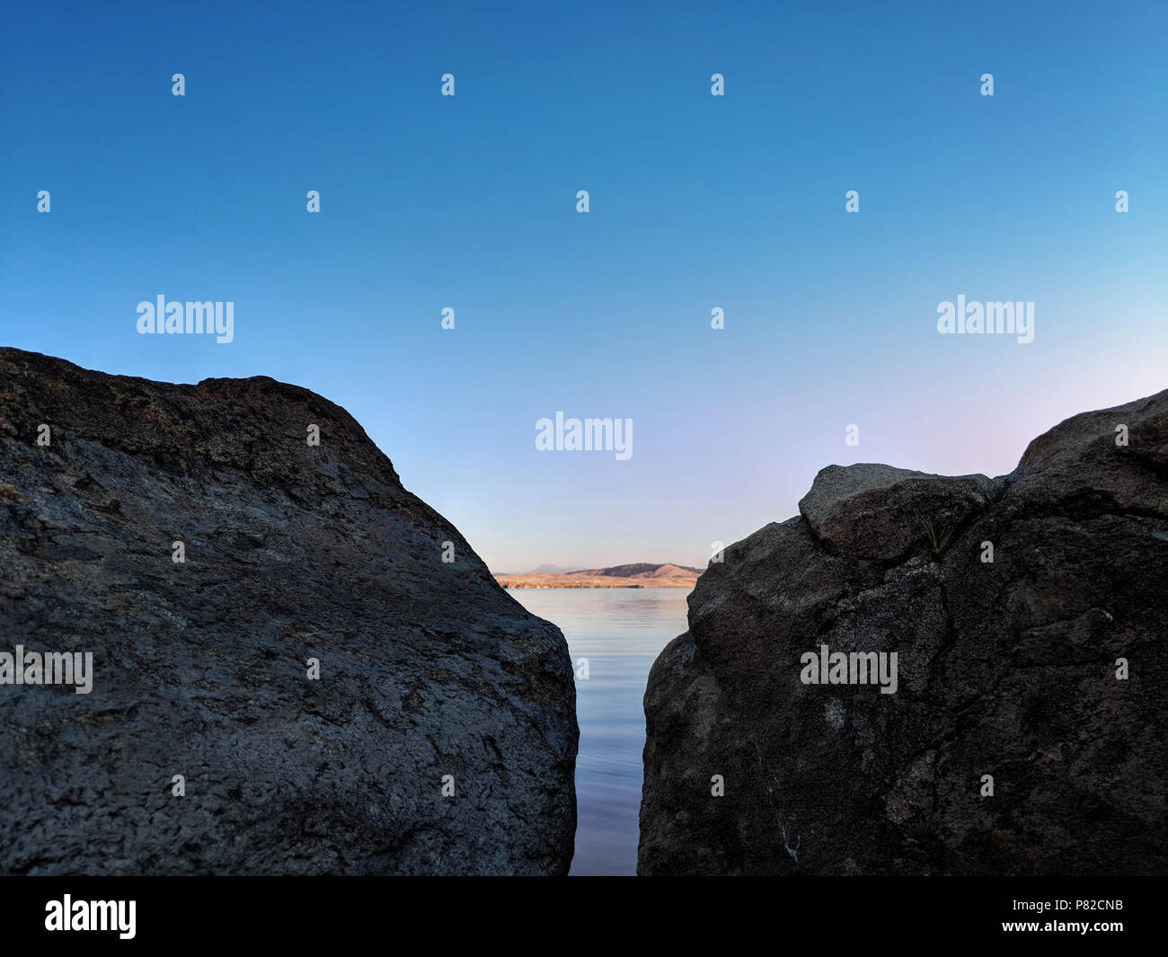 Twin Boulder Cliffs on Lake Stock Photo - Alamy