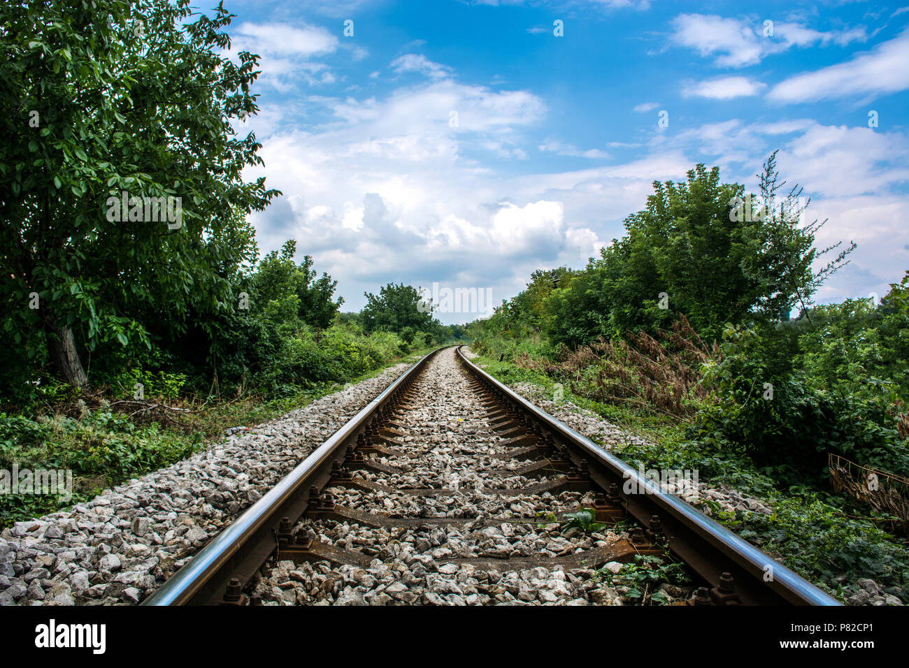 Railroad against beautiful blue cloudy sky in nature. Railway tracks ...