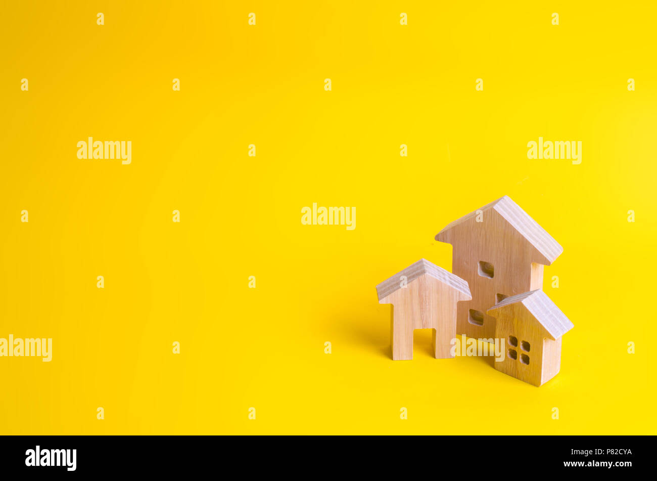 Three houses on a yellow background. Buying and selling of real estate ...