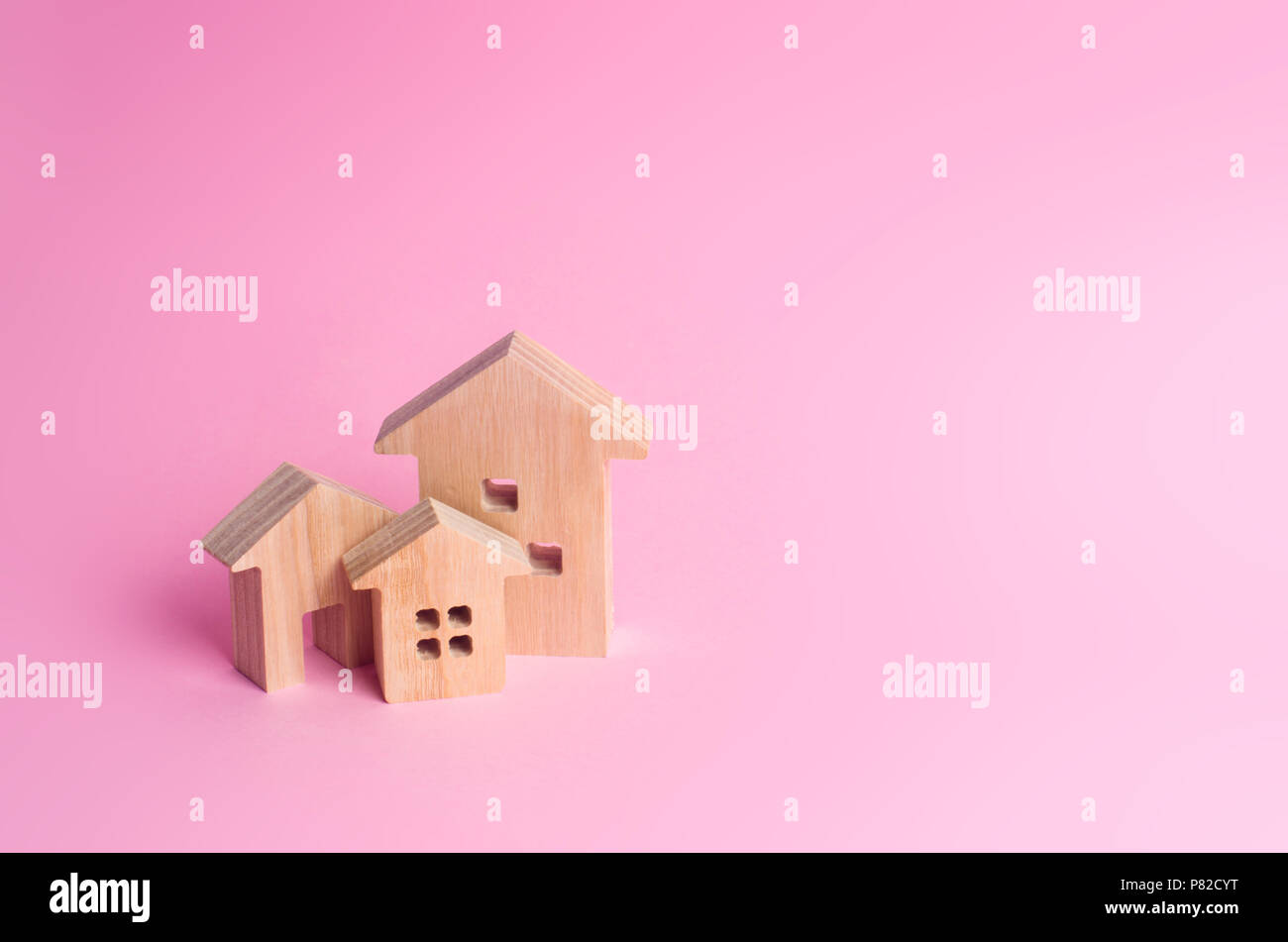 Three houses on a pink background. Buying and selling of real estate ...