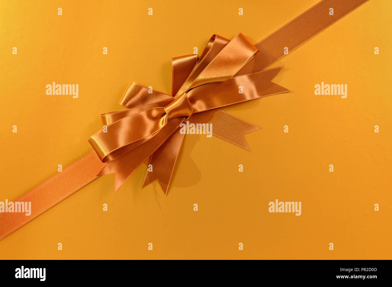 Gold gift background ribbon and bow diagonal Stock Photo - Alamy