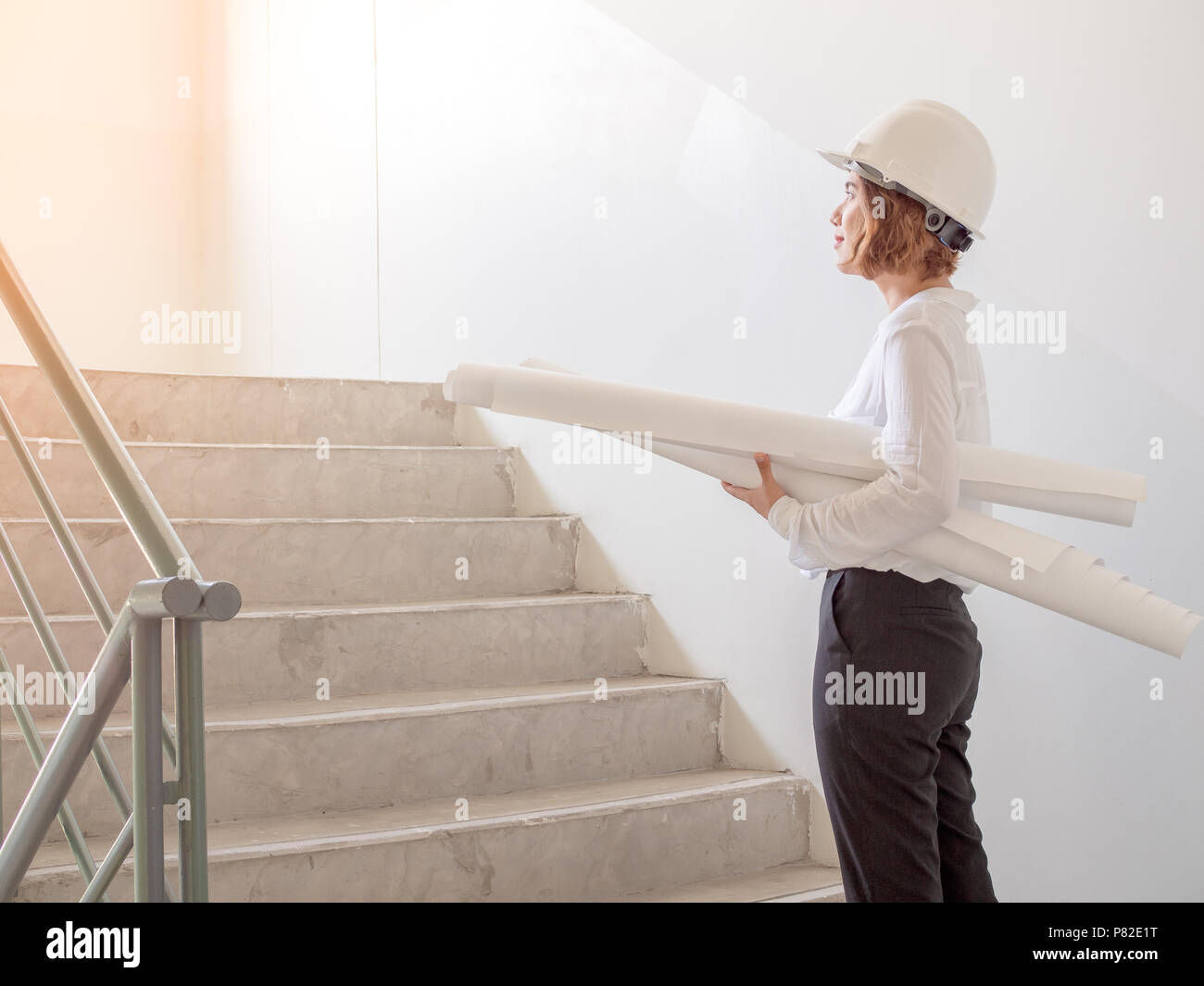 Beautiful asian woman engineer curly short hair wearing white safety ...