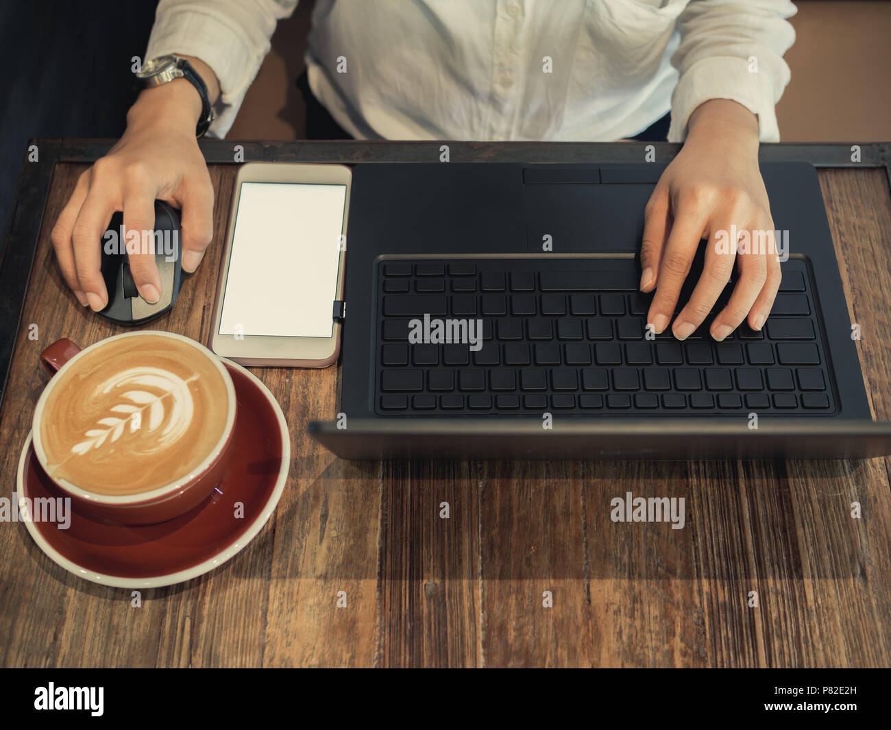 Hand typing on Black laptop computer and clicking computer mouse ...