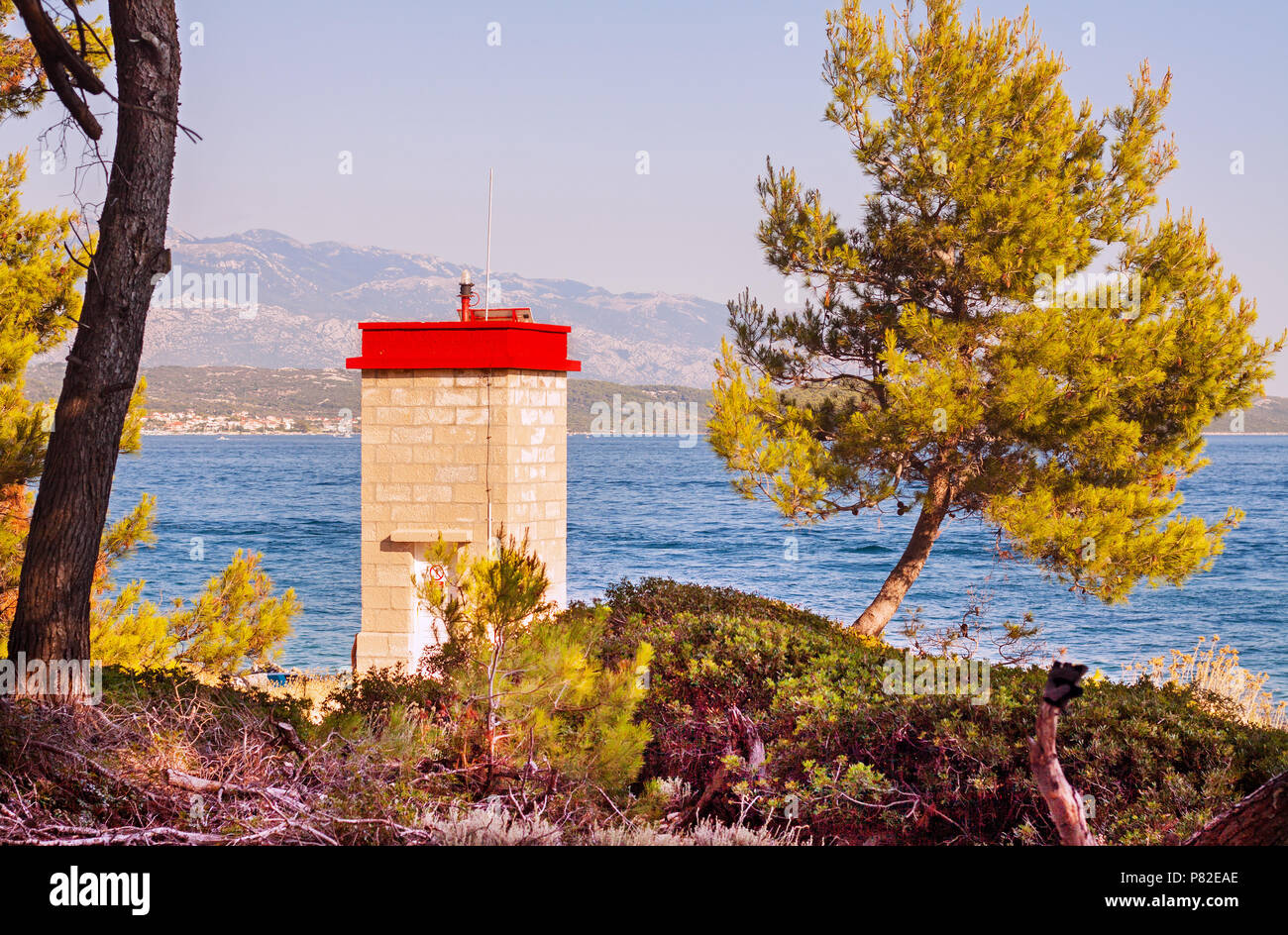 Port beacon sea light on coast close to Rab island Stock Photo - Alamy