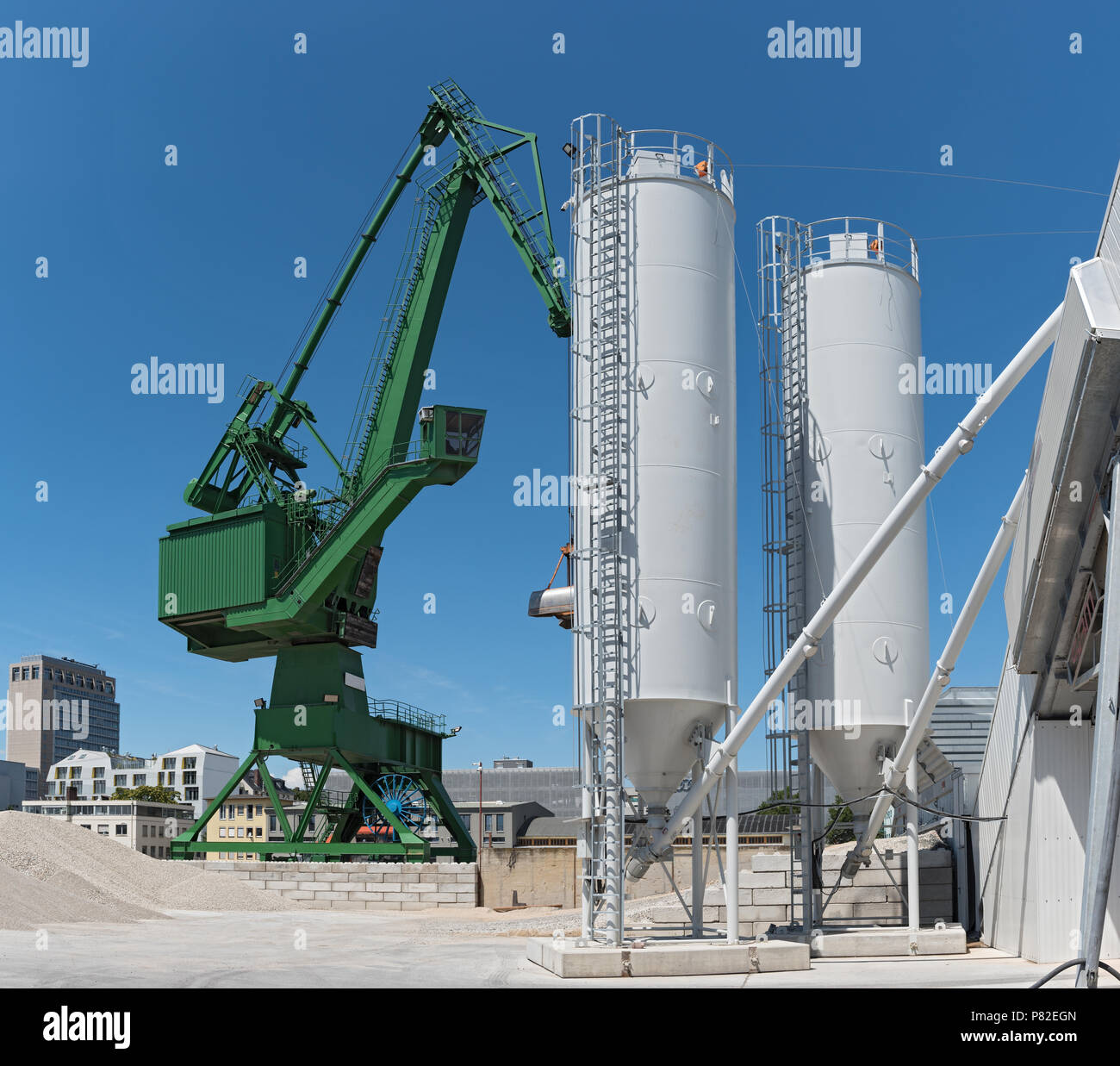 Exterior view of a cement factory with green crane Stock Photo - Alamy