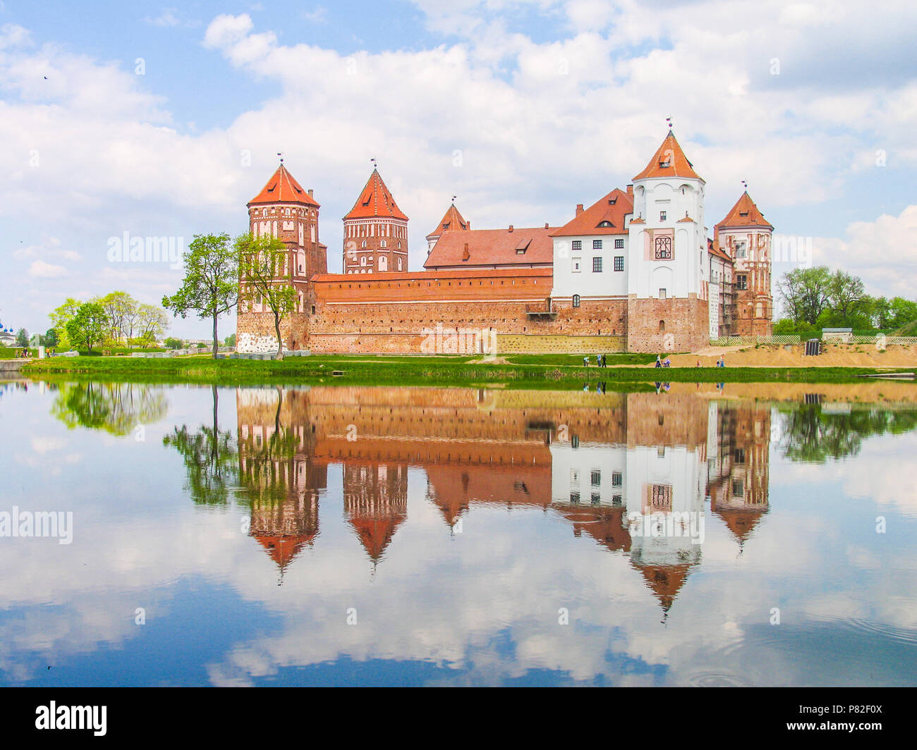 Mir, Belarus. Castle Complex Mir reflected in lake On Sunny Day with ...
