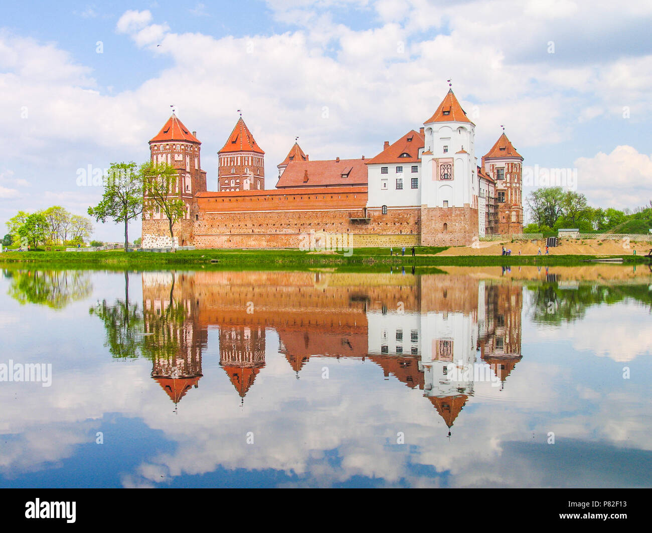Mir, Belarus. Castle Complex Mir reflected in lake On Sunny Day with ...