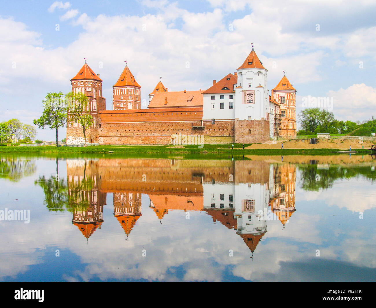Mir, Belarus. Castle Complex Mir reflected in lake On Sunny Day with ...