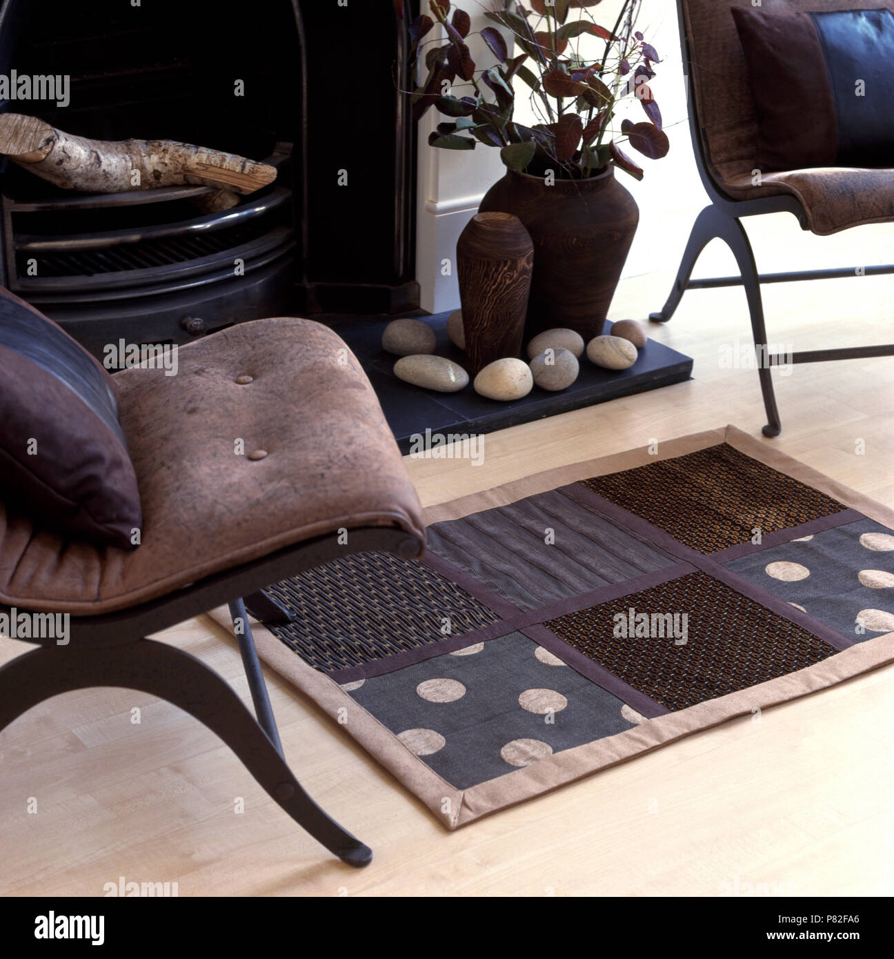 Small patchwork rug in muted blue colours beside fireplace with large ...