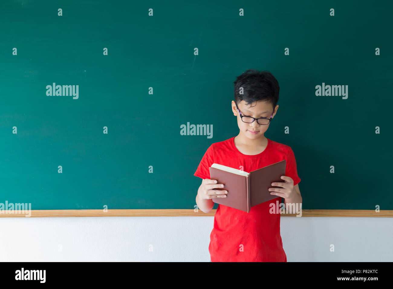 Boy At Blank Chalkboard