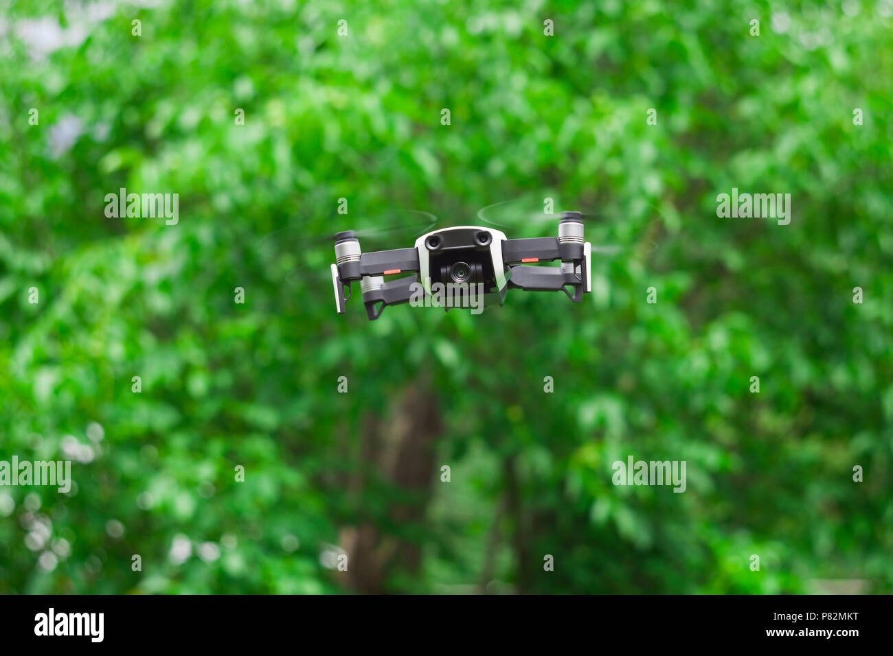 hobby drone with video camera flying in green tree background Stock ...