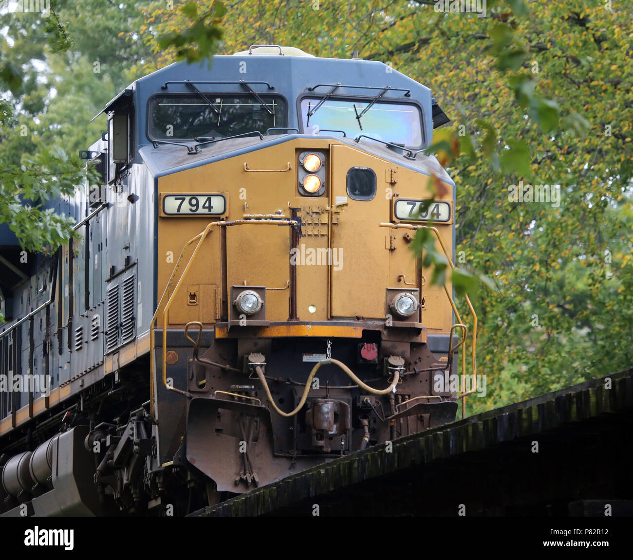 closeup of front of train engine on trestle looking up from below ...