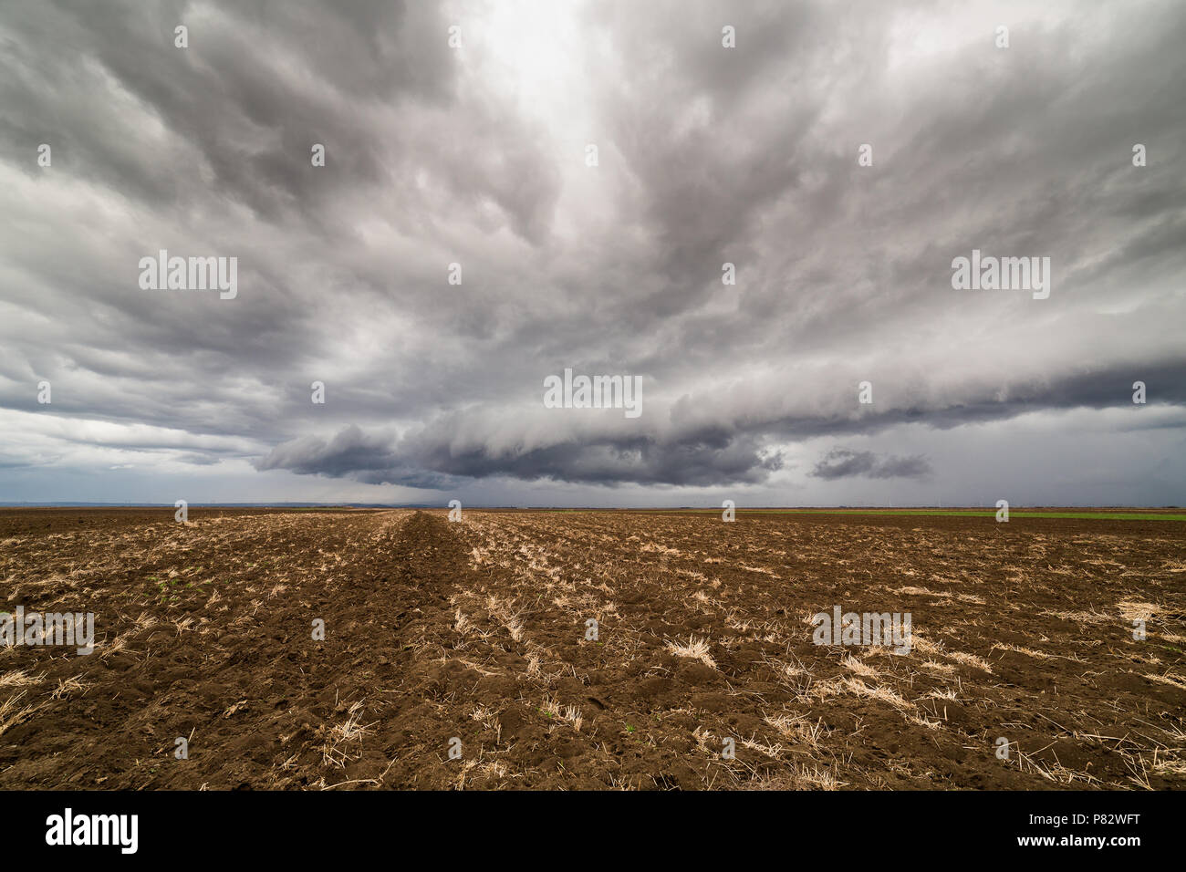Storm clouds over arable land Stock Photo - Alamy