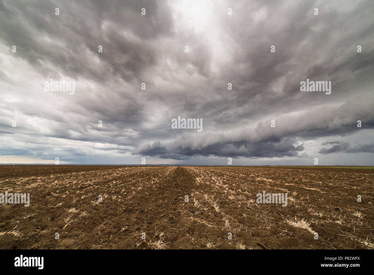 Storm clouds over arable land Stock Photo - Alamy