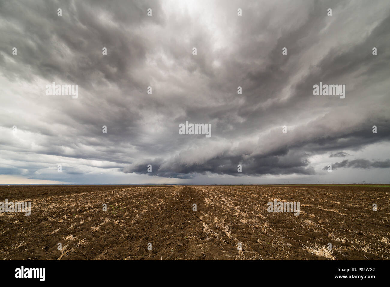 Storm clouds over arable land Stock Photo - Alamy