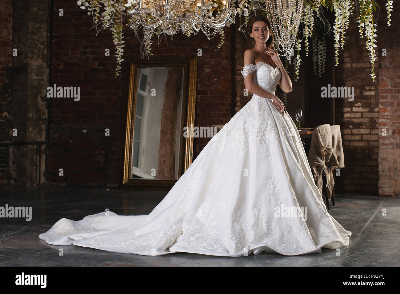 Portrait of a beautiful bride. Lace dress. Wedding hairstyle and makeup ...