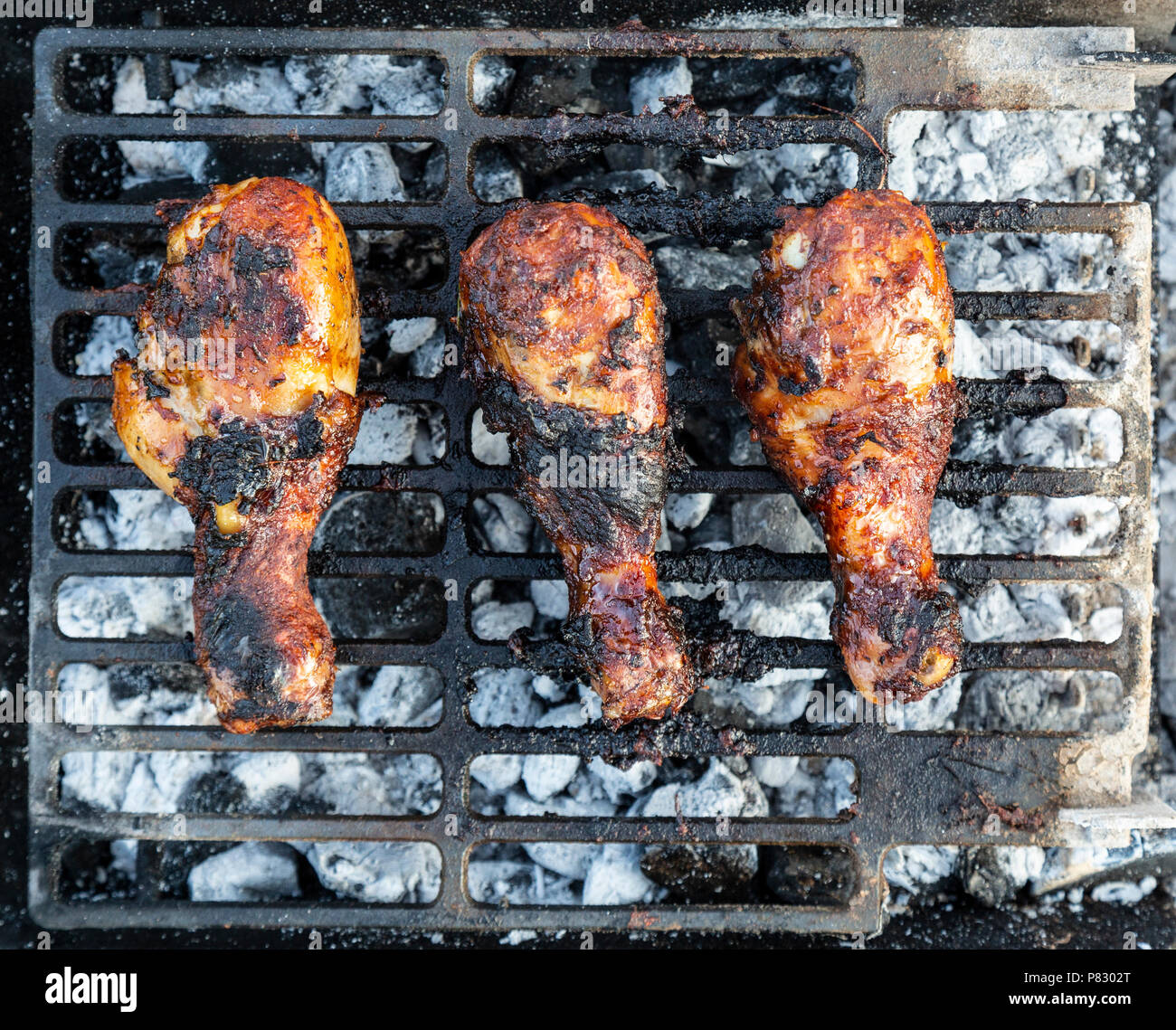 Chicken drumsticks,or Chicken Thighs being cooked on a BBQ, barbecue ...
