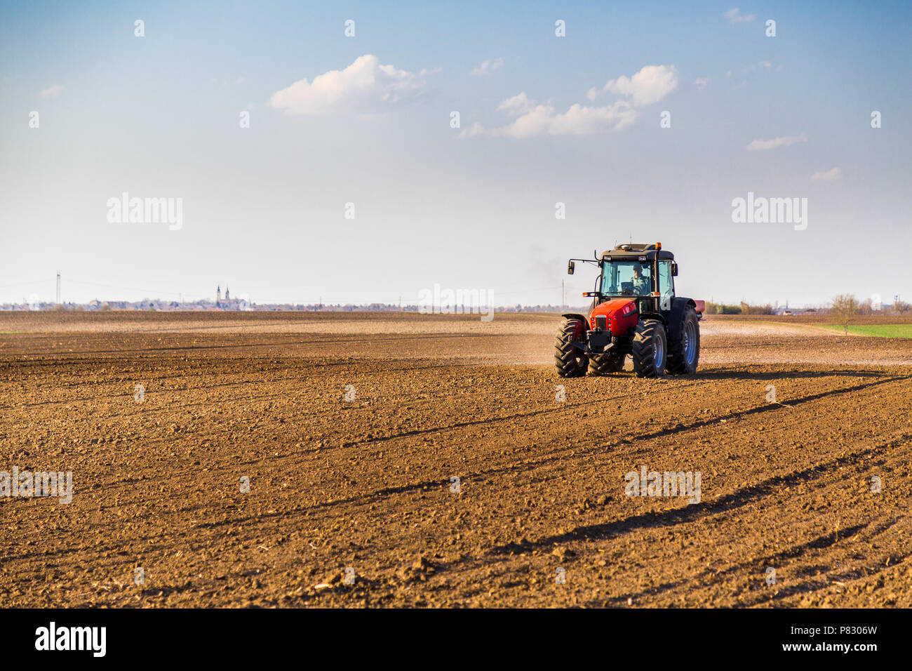 Farmer fertilizing arable land with nitrogen, phosphorus, potassium ...
