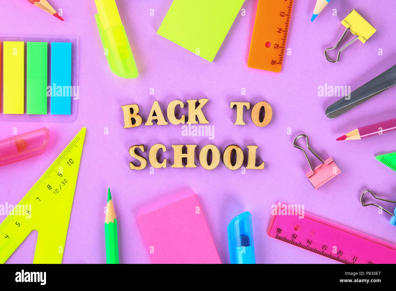 School supplies on violet background ready for your design. Flat lay ...