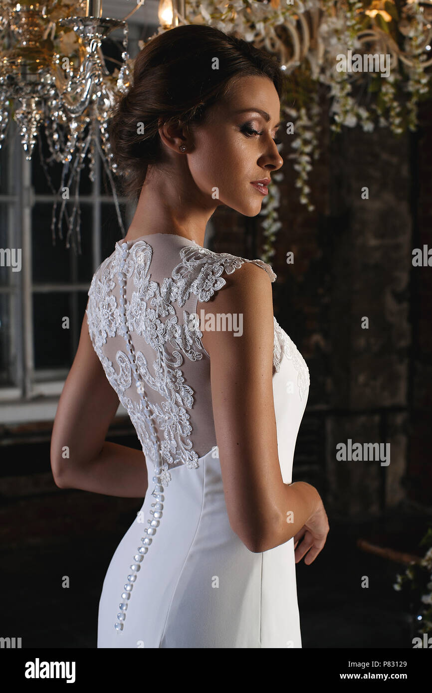 Portrait of a beautiful bride. Lace dress. Wedding hairstyle and makeup ...