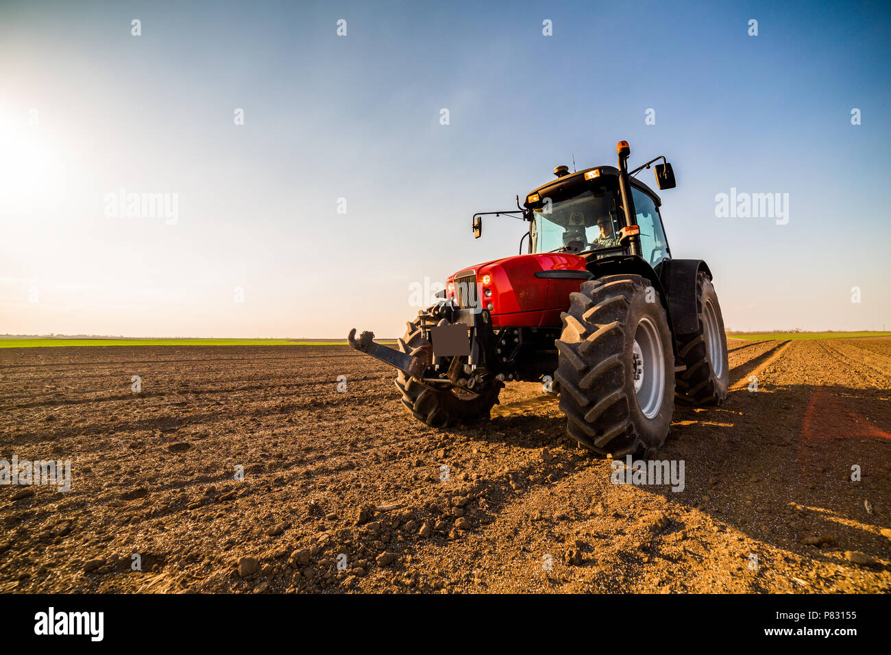 Farmer fertilizing arable land with nitrogen, phosphorus, potassium ...