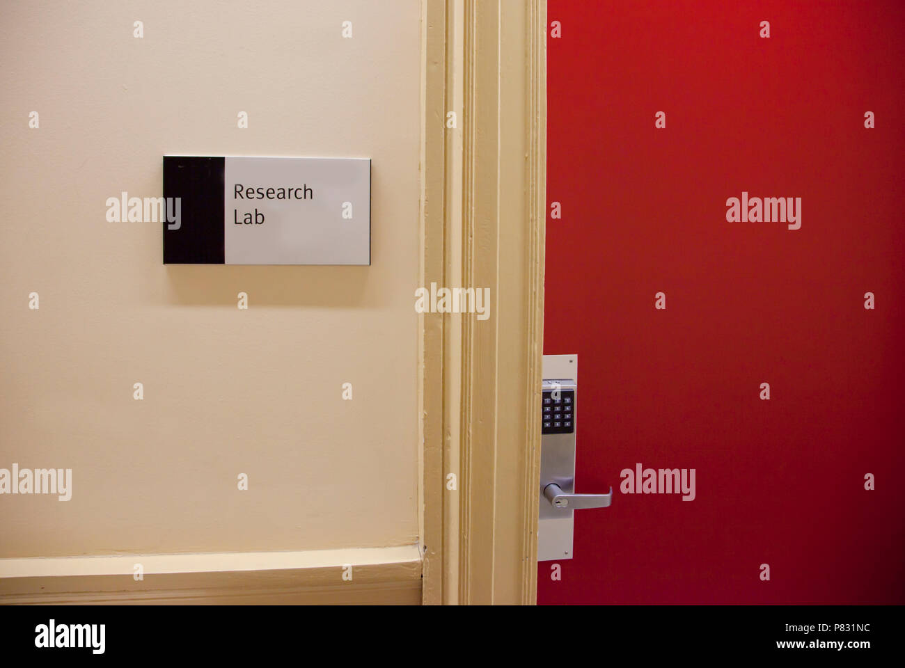 Sign on a red door with a locked keypad says the entrance to a Research ...