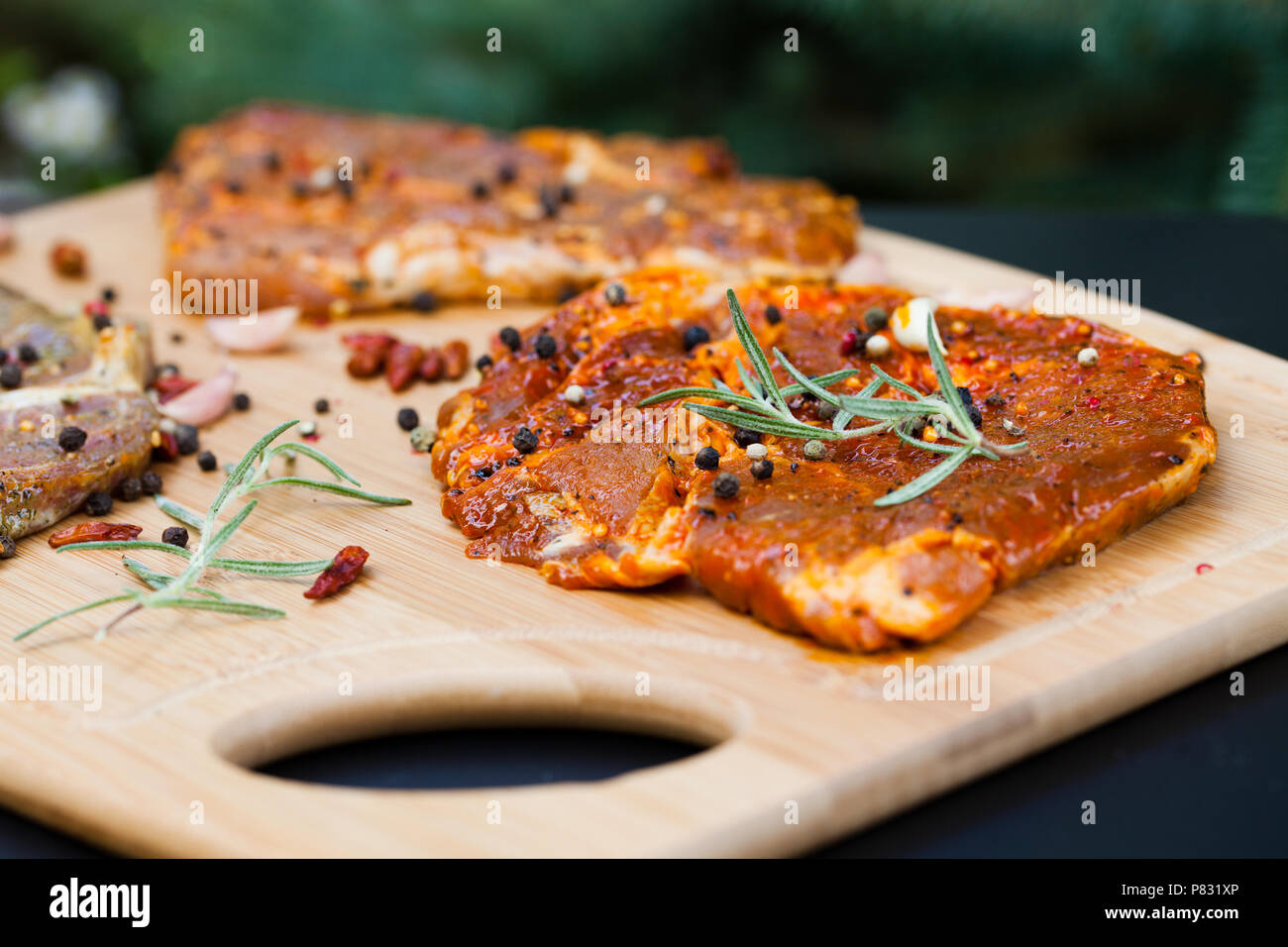 raw meat with herbs and rosemary ready for barbecue Stock Photo - Alamy