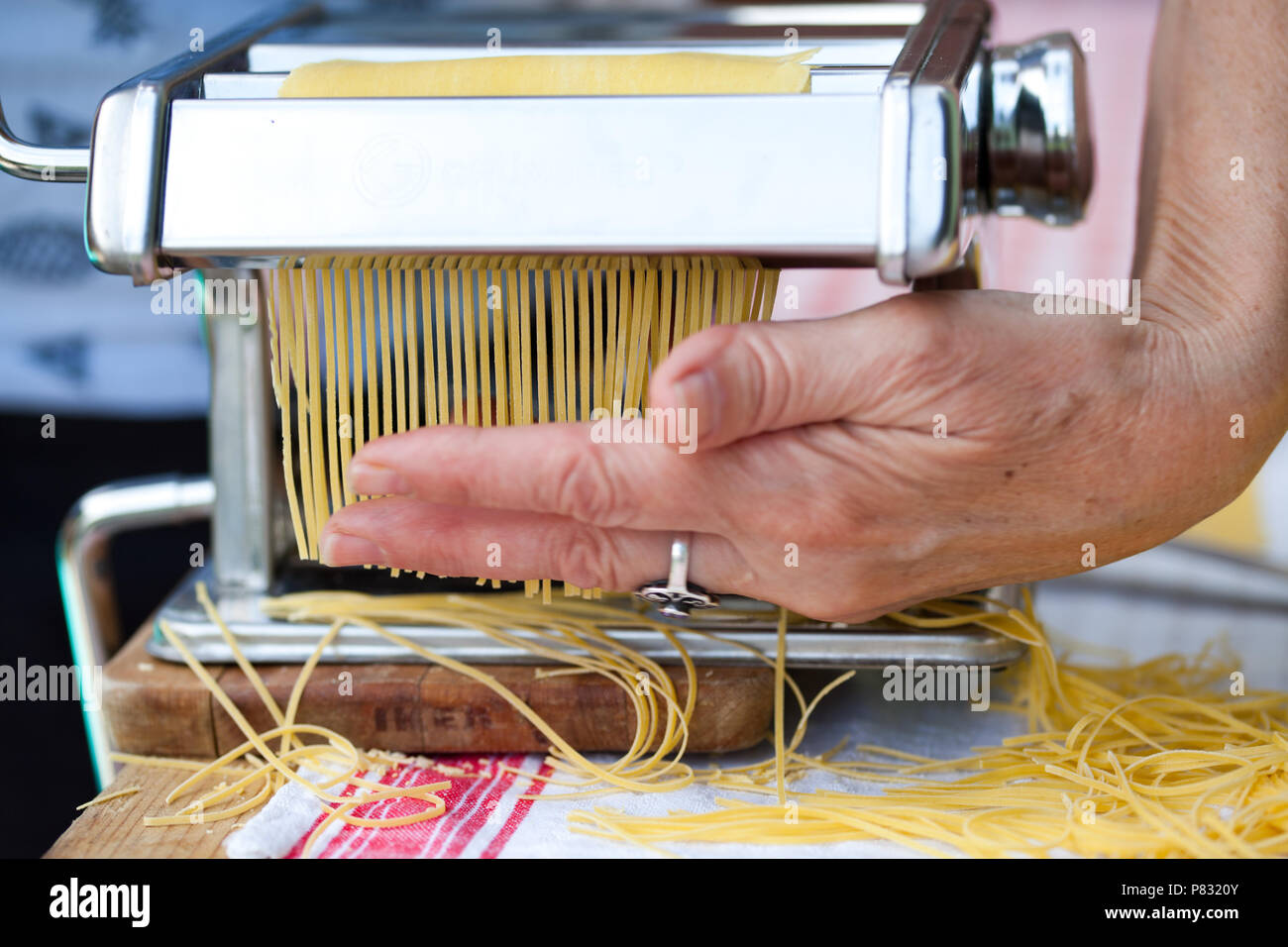 woman's hands cutting home made pasta Stock Photo - Alamy
