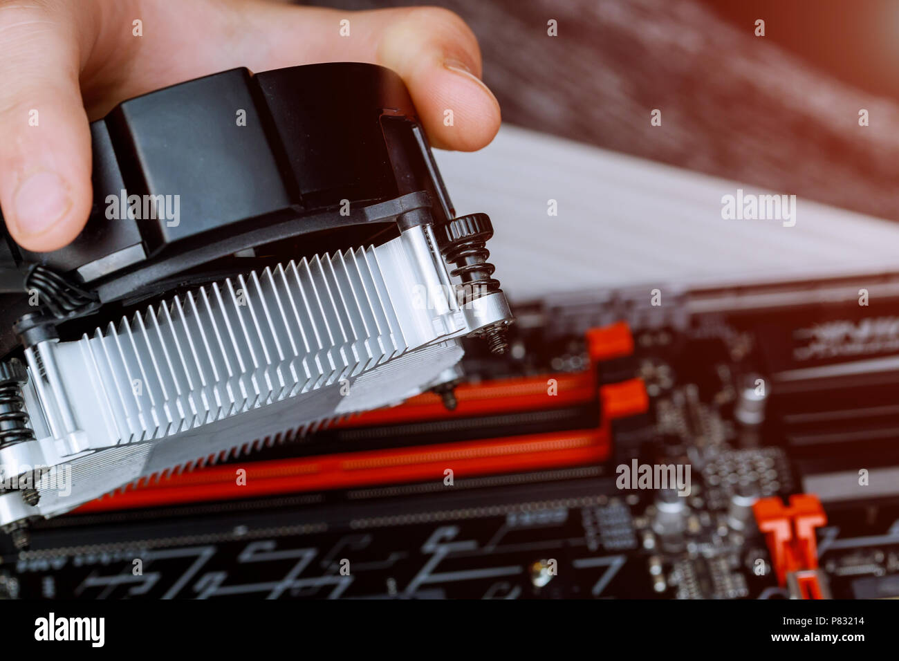 Technician hands installing CPU cooler fan on a computer pc motherboard ... Technician hands installing CPU cooler fan on a computer pc motherboard ...