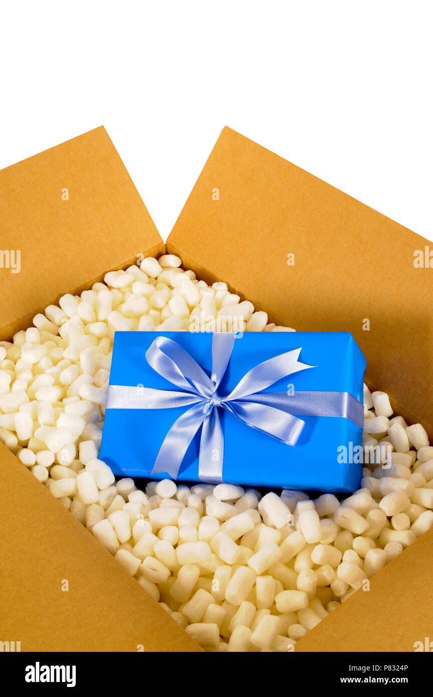 Cardboard shipping delivery box with blue gift inside and polystyrene ...
