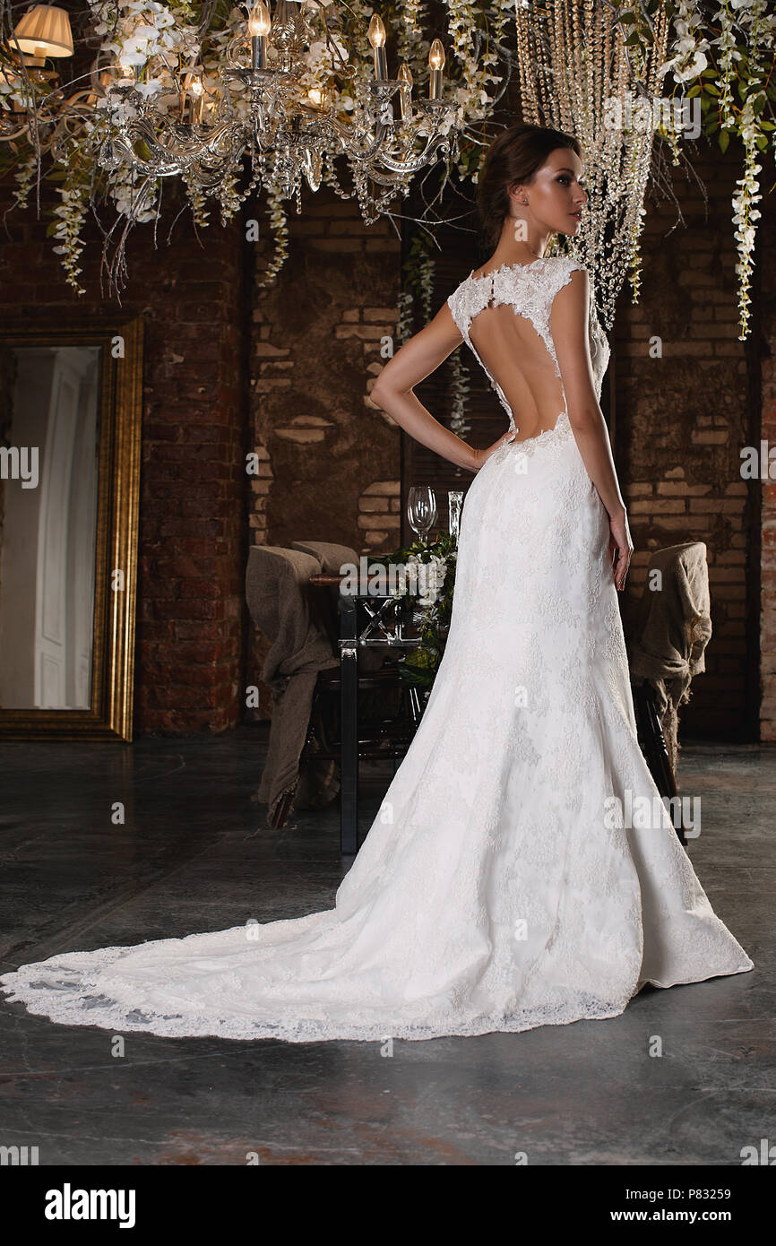 Portrait of a beautiful bride. Lace dress. Wedding hairstyle and makeup ...