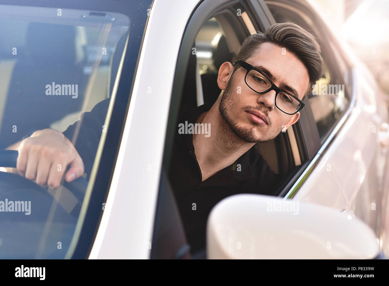 Portrait of a handsome guy driving his car Stock Photo - Alamy