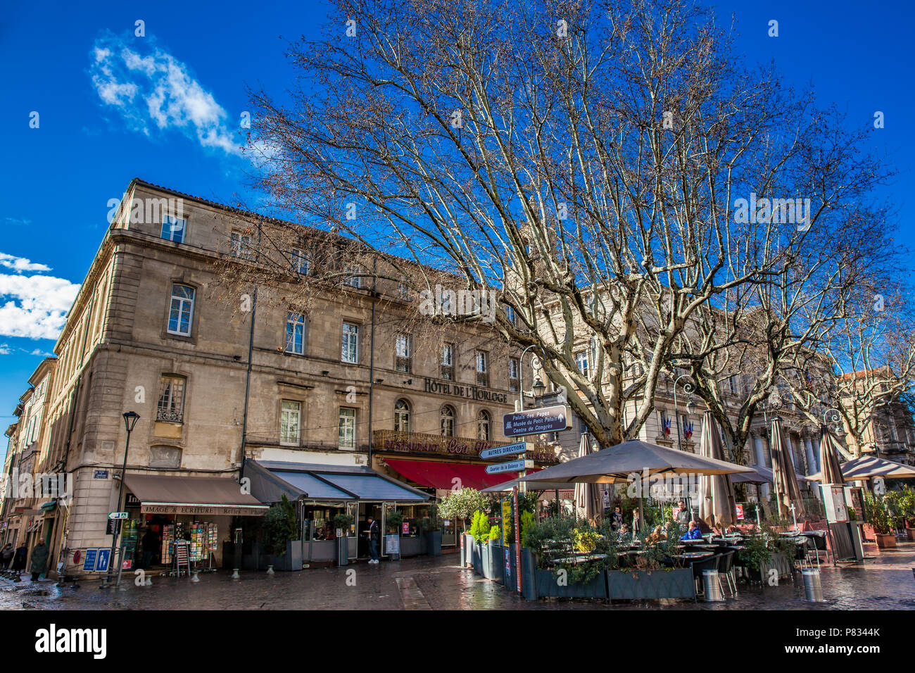 AVIGNON, FRANCE - MARCH, 2018: Restaurants and shops at the Clock Tower ...