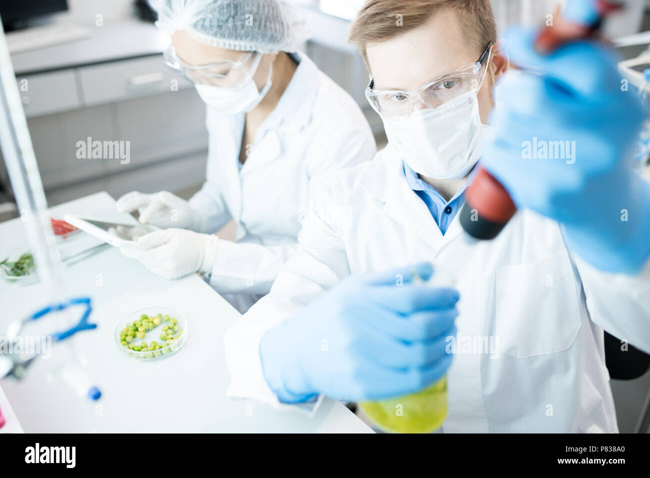 Scientist holding tube chemical laboratory hi-res stock photography and ...