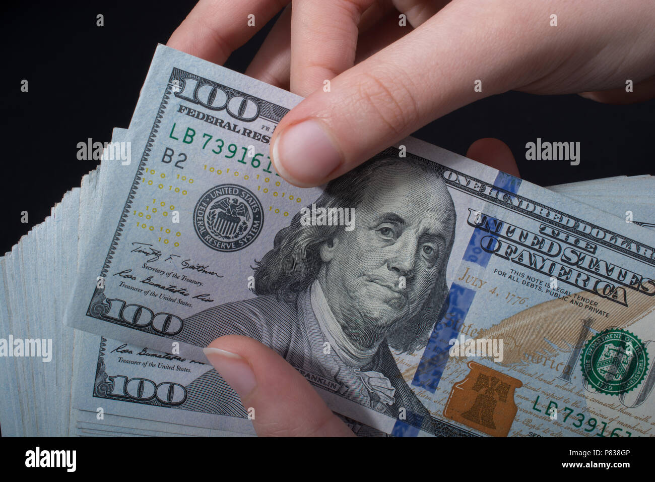 Hand holding American dollar banknotes isolated on white background ...