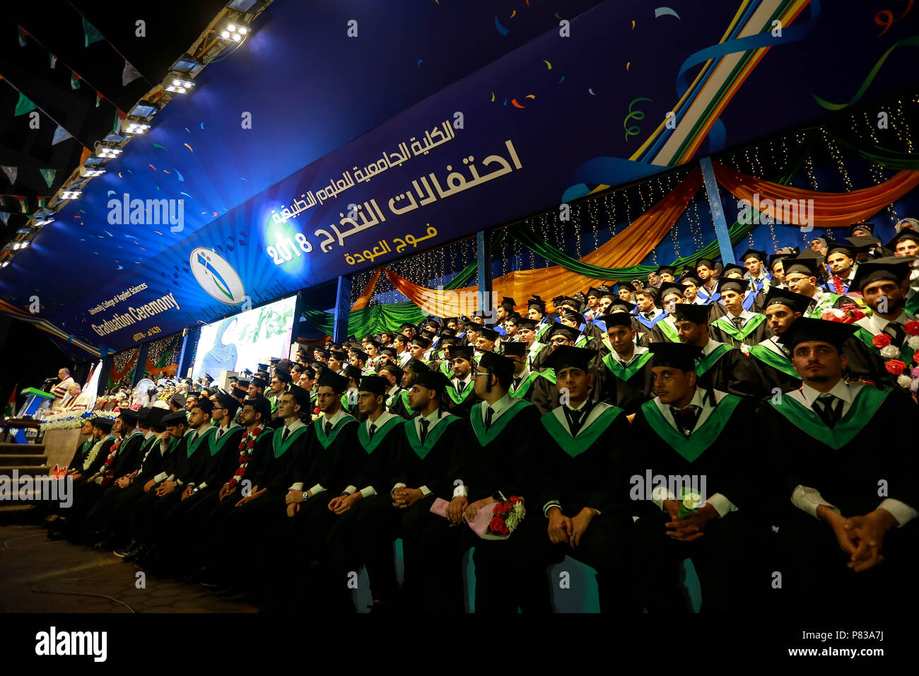 Gaza, Palestine. 8th July, 2018. Men graduates sit at their graduation ...