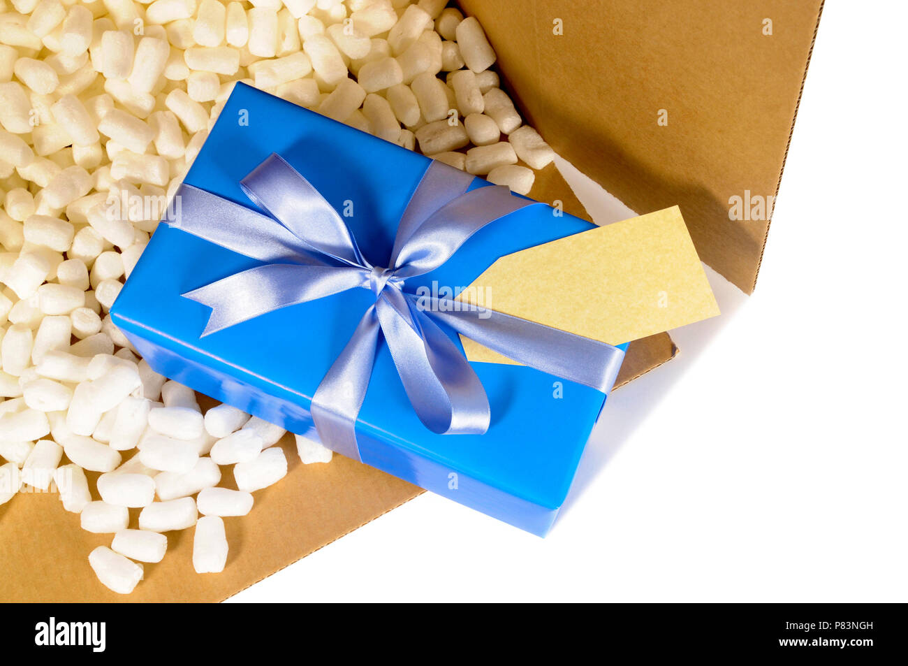 Cardboard shipping delivery box with blue gift inside and polystyrene ...