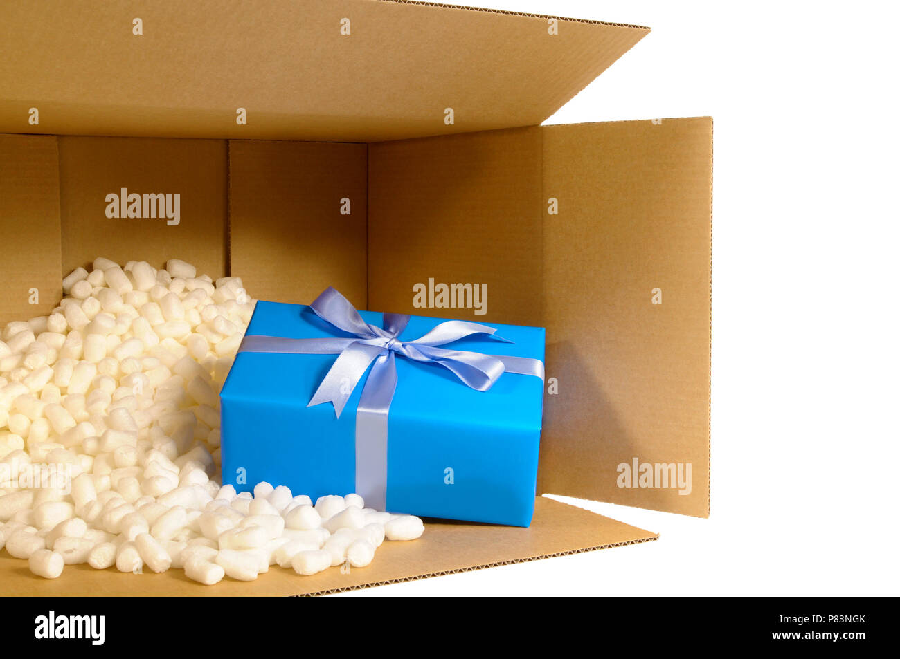 Cardboard shipping delivery box with blue gift inside and polystyrene ...