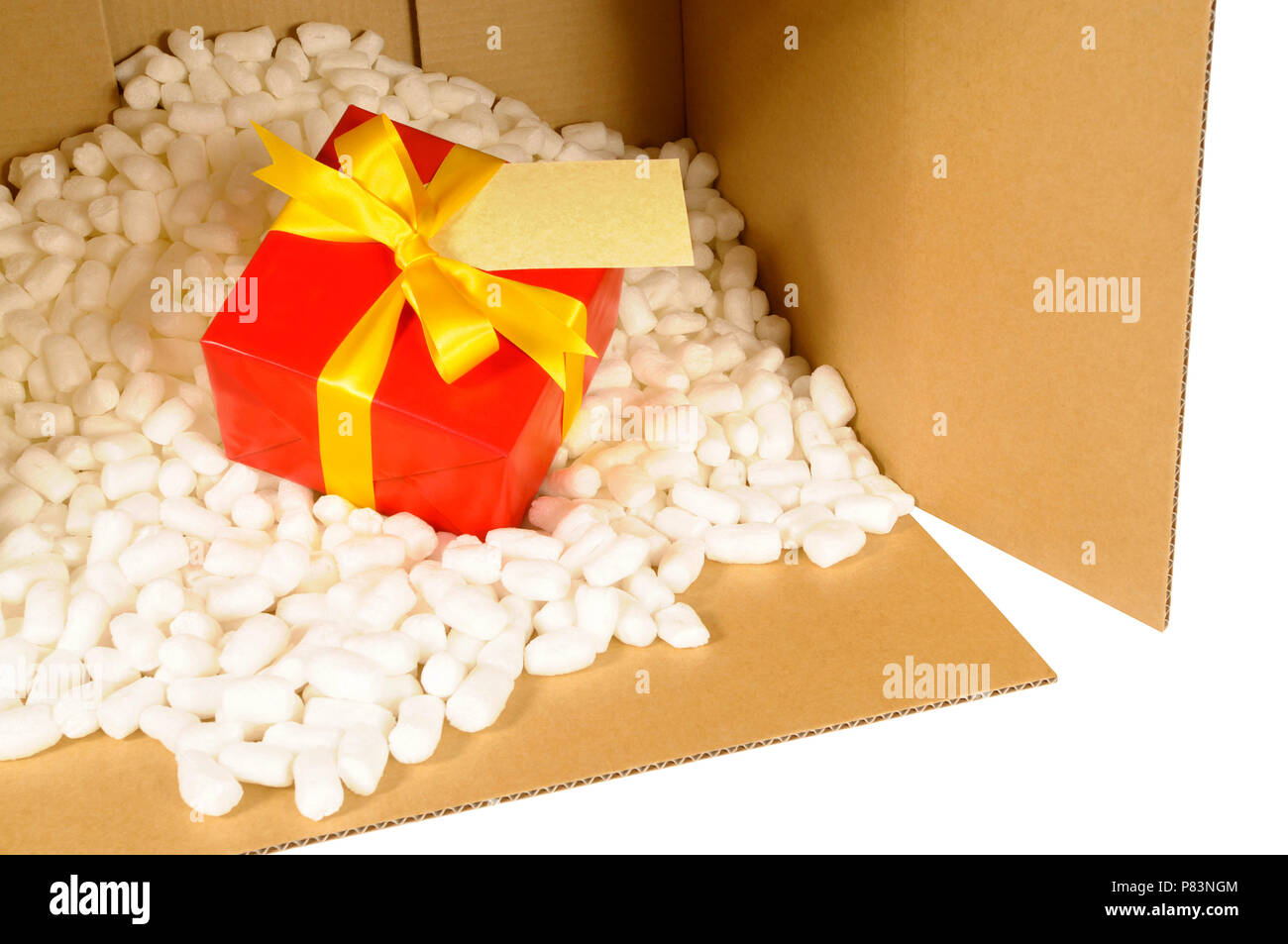 Cardboard shipping delivery box with red gift inside and polystyrene ...