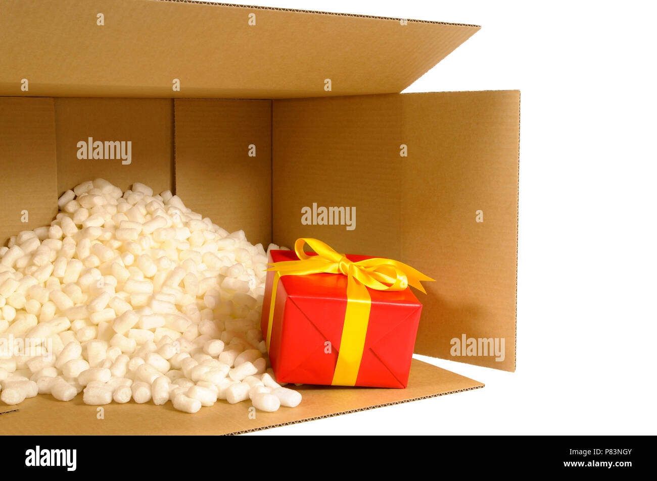 Cardboard shipping delivery box with red gift inside and polystyrene ...