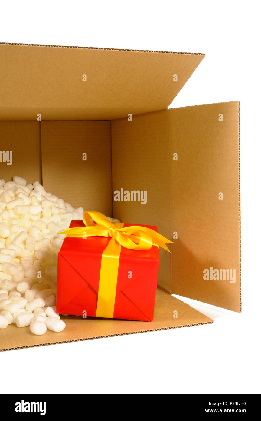 Cardboard shipping delivery box with red gift inside and polystyrene ...