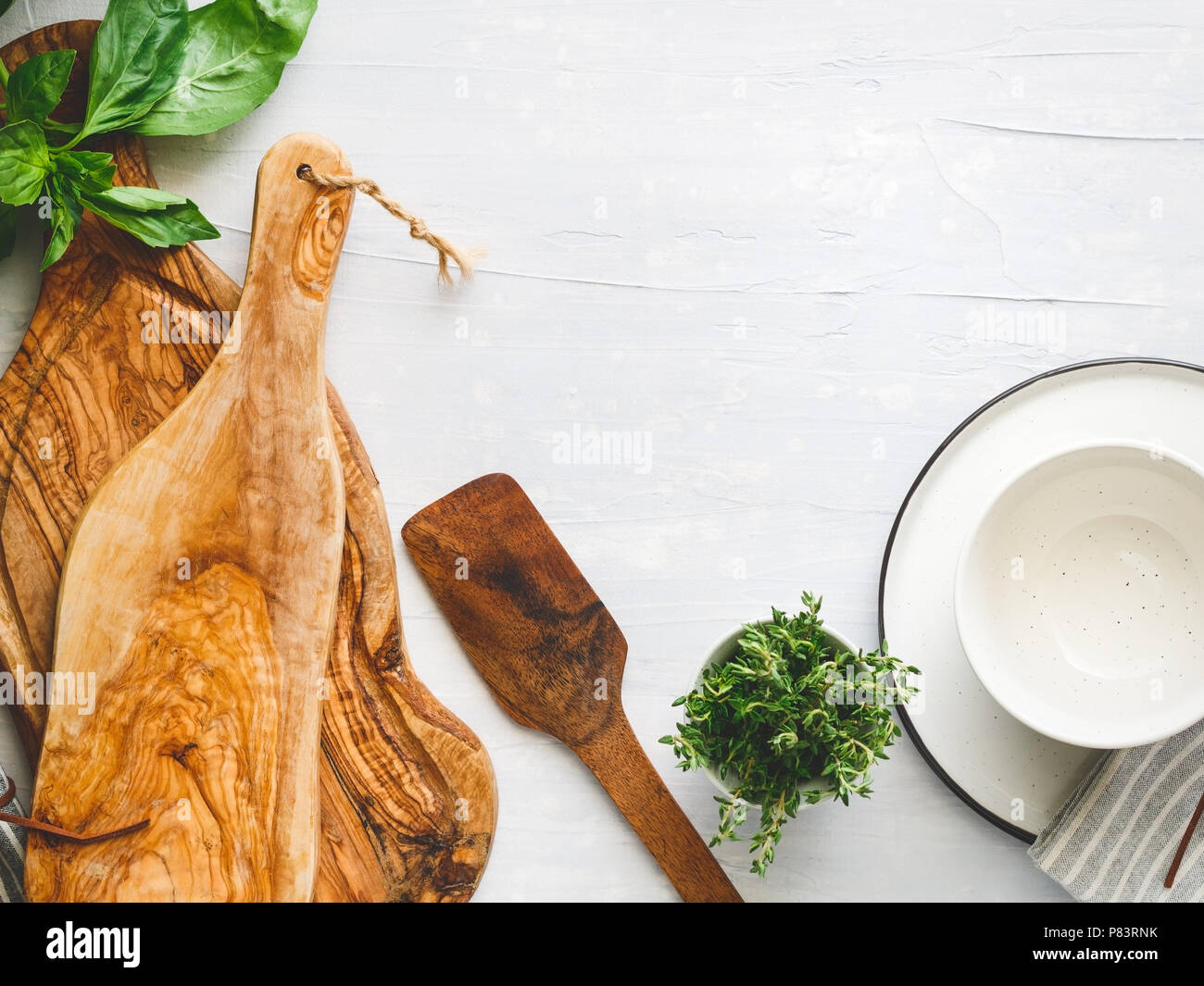 Kitchen utensils on a white table in a modern kitchen. Place for text ...