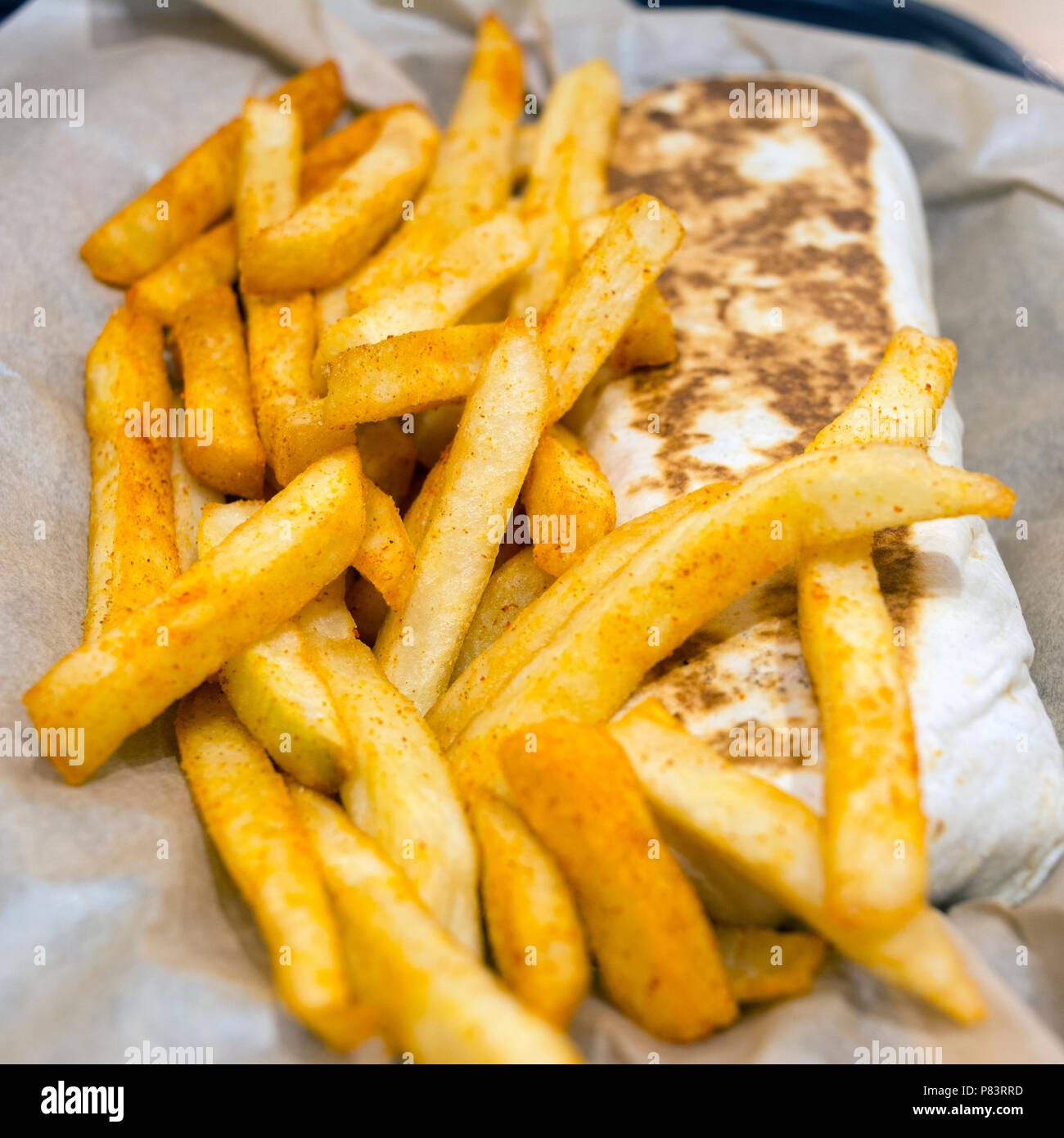 Close up on a burrito with fries Stock Photo - Alamy