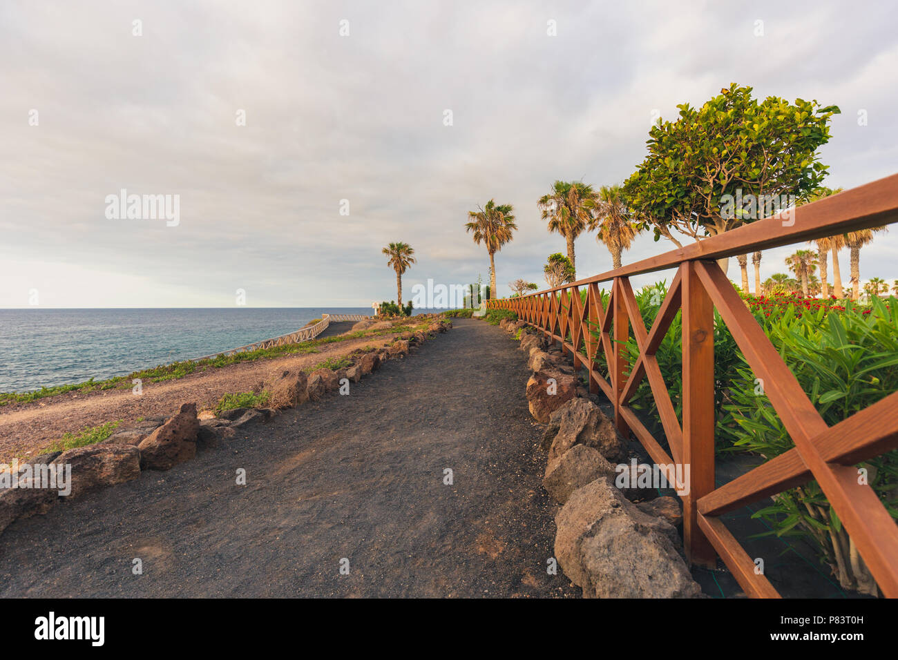 Ground path with handrails along rocky coastline Stock Photo - Alamy