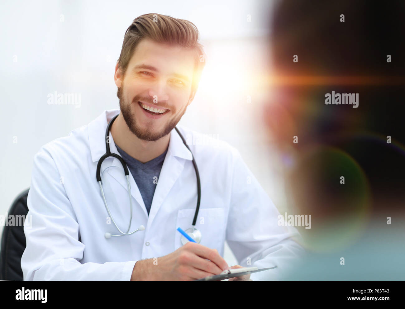 closeup.doctor writing a prescription to her patient Stock Photo - Alamy